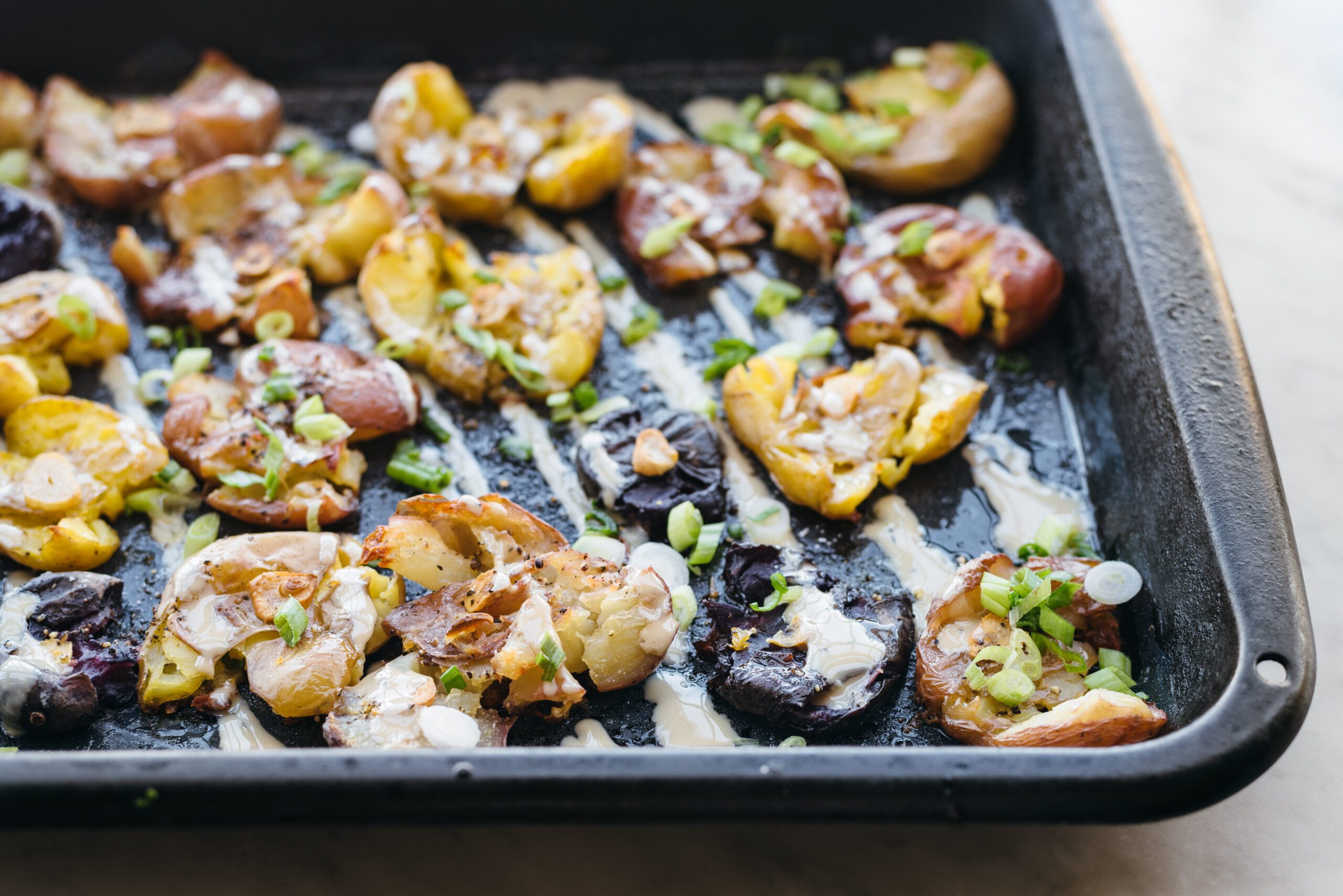 Smashed Roasted Potatoes with Garlic and Tahini - Edible San Diego
